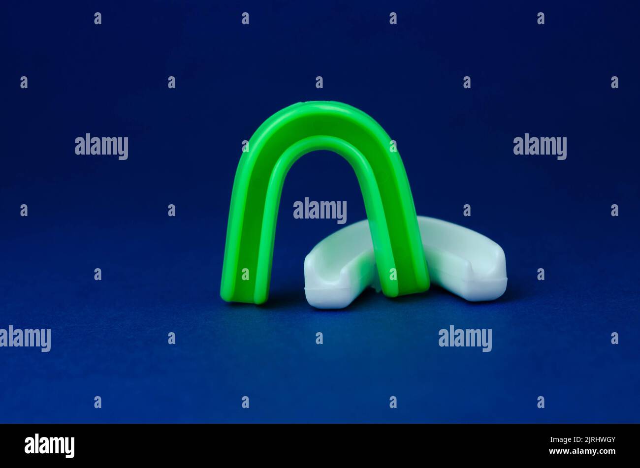 two rubber boxing mouth guards, white and green, protection for lips ...