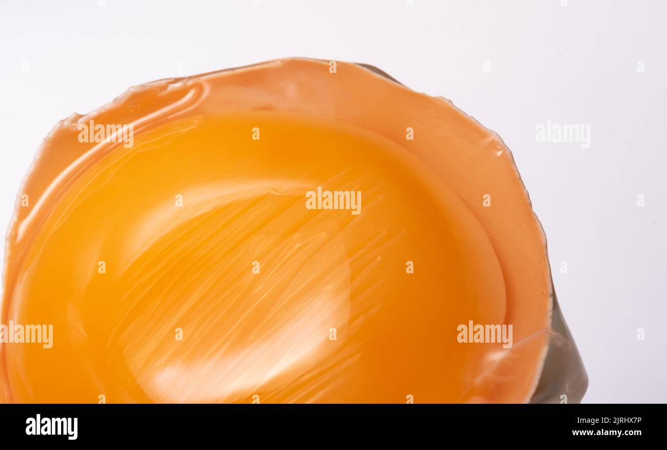 Egg yolk in a shell isolated on a white background. Egg yolk close-up ...
