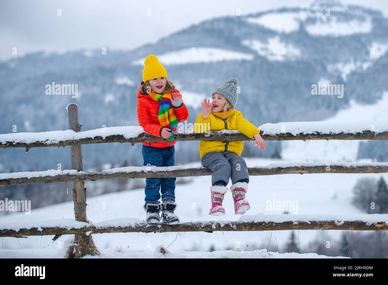 Funny little children in winter outdoor. Smiling kids friends in frost ...