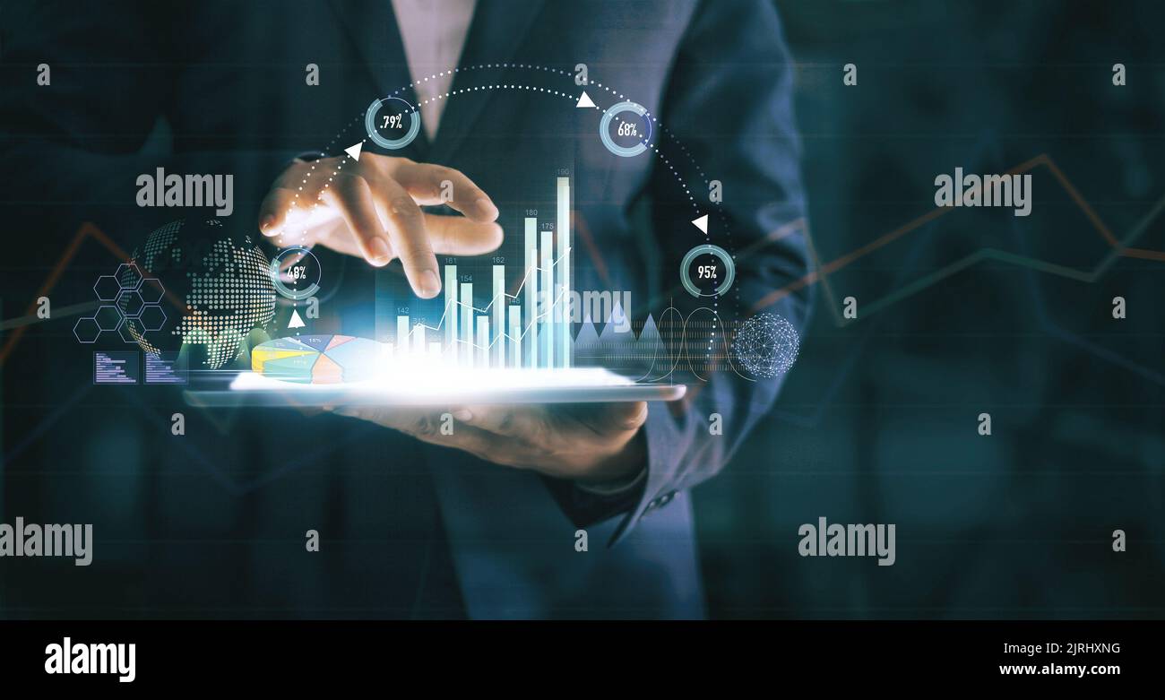 Businessman using tablet analyzing sales data and economic growth graph ...
