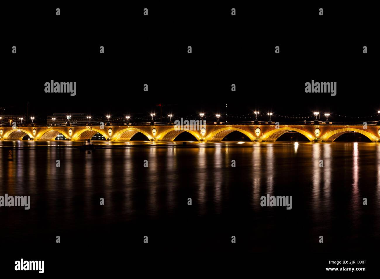 Night view of the famous bridge of Bordeaux called Le Pont de Pierre ...