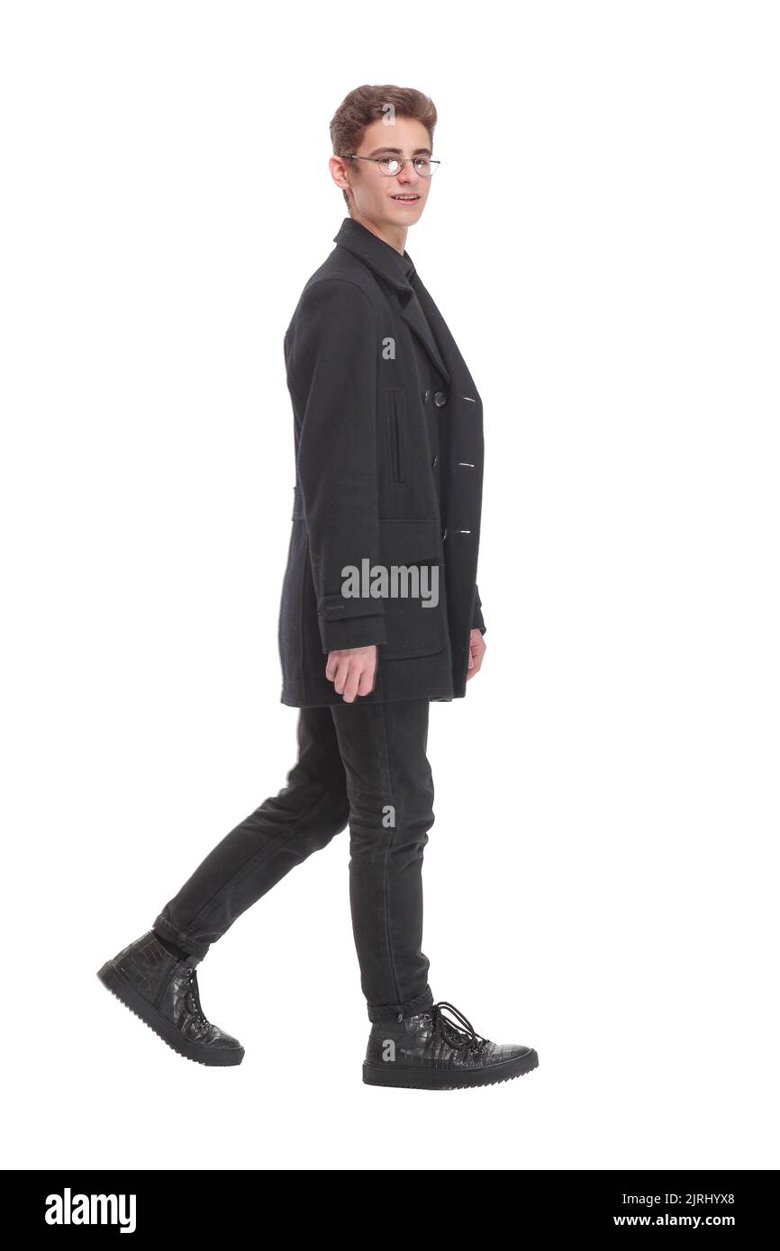 Side view of a fashion young man walking forward over white Stock Photo ...