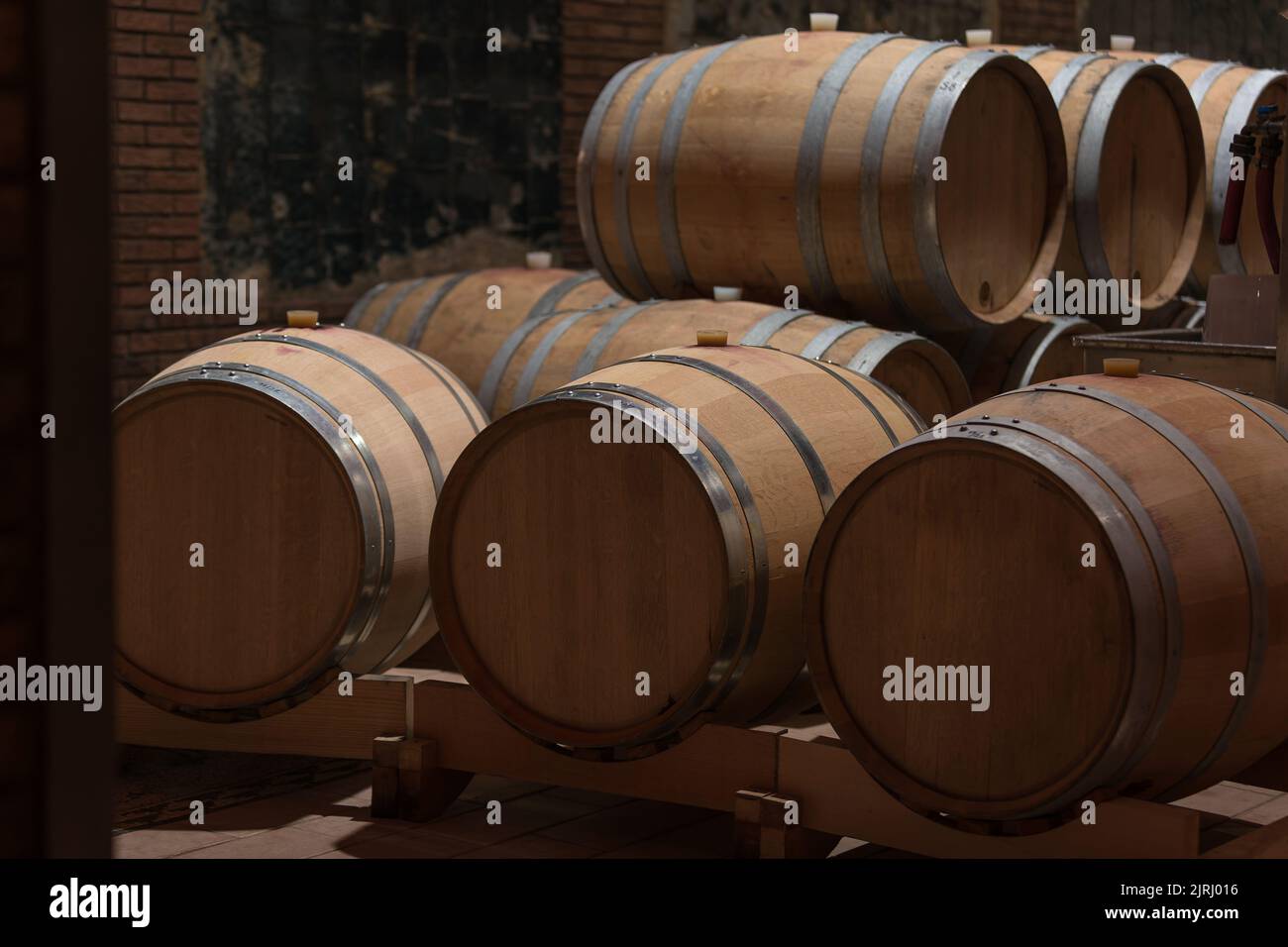 Underground dark cool arched wine cellar, storage room with large ...