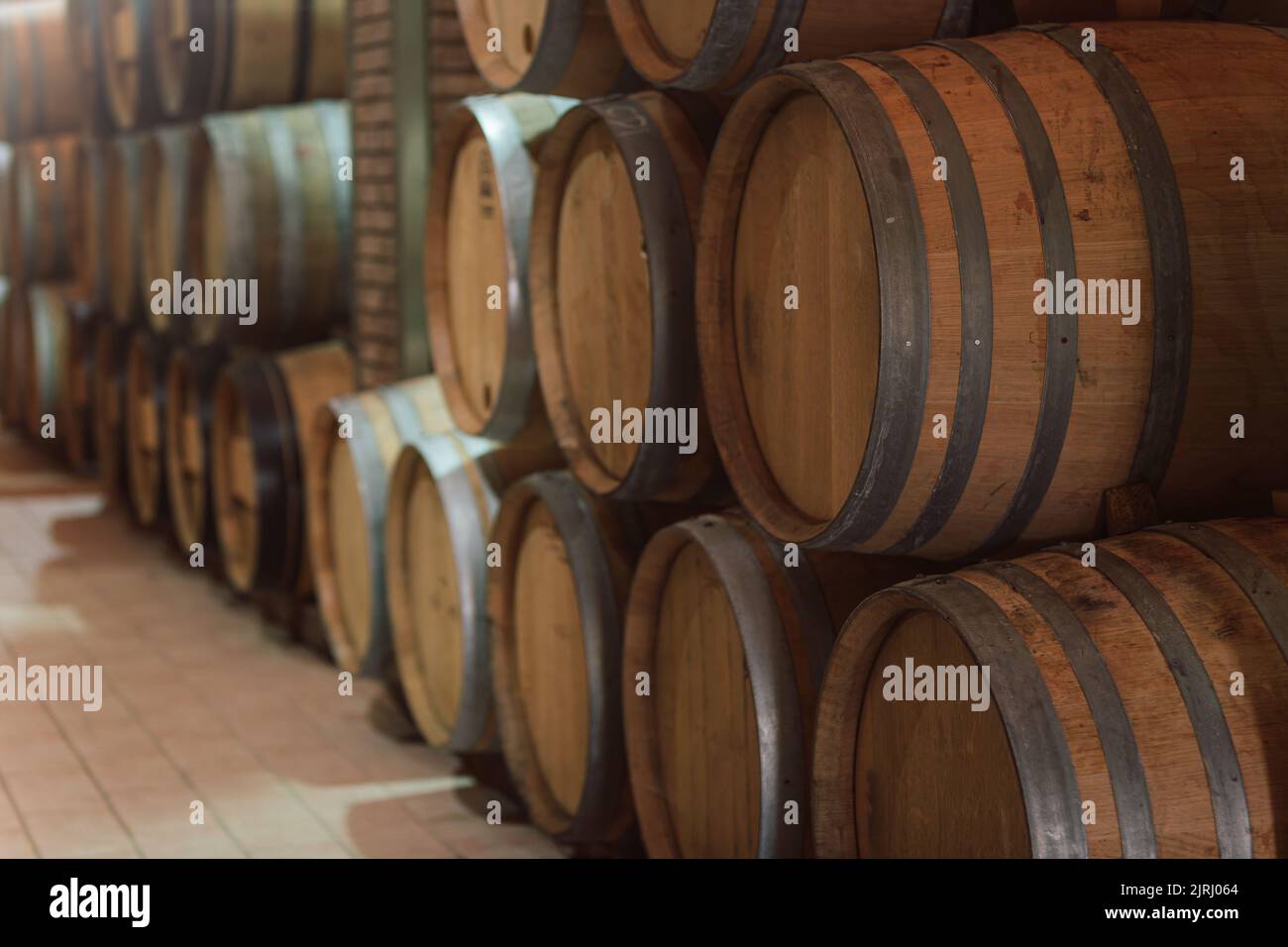 The ambiance of the traditional wine cellar, aging red wine barrels ...