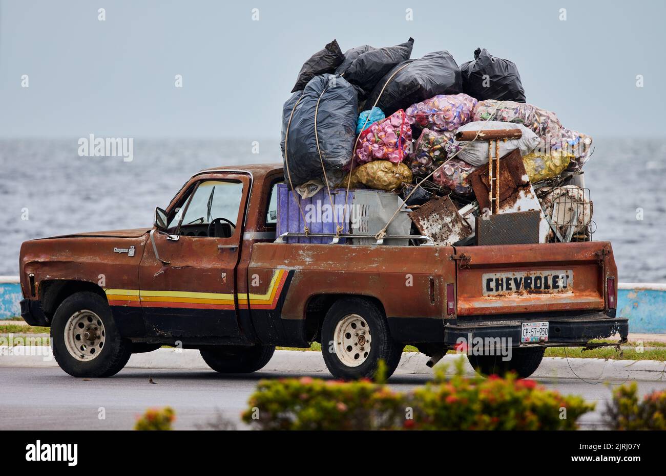 A trash car in working hour driving by the sea in Campeche, Mexico ...