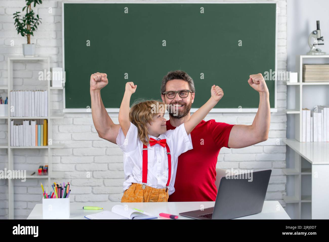 Excited school teacher with a schoolboy. Teacher and students from ...