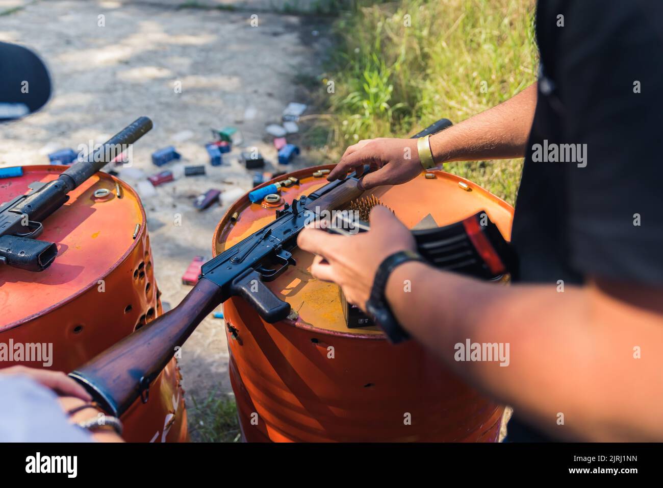 Unrecognizable European man touching, cleaning, and changing clip of a ...
