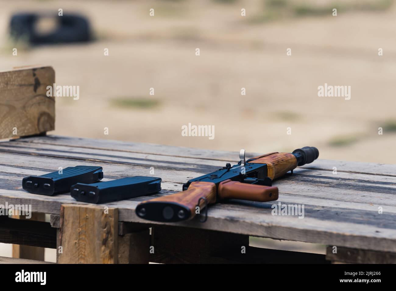 Black gun on brown table hi-res stock photography and images - Alamy
