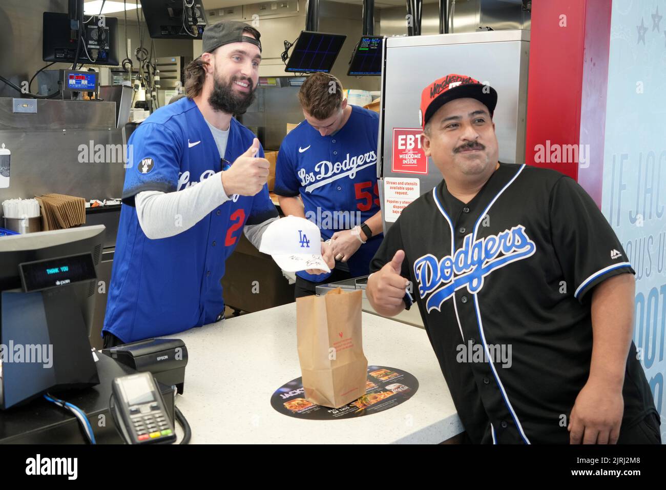 Los Angeles Dodgers pitcher Tony Gonsolin (left) poses with a Dodgers ...