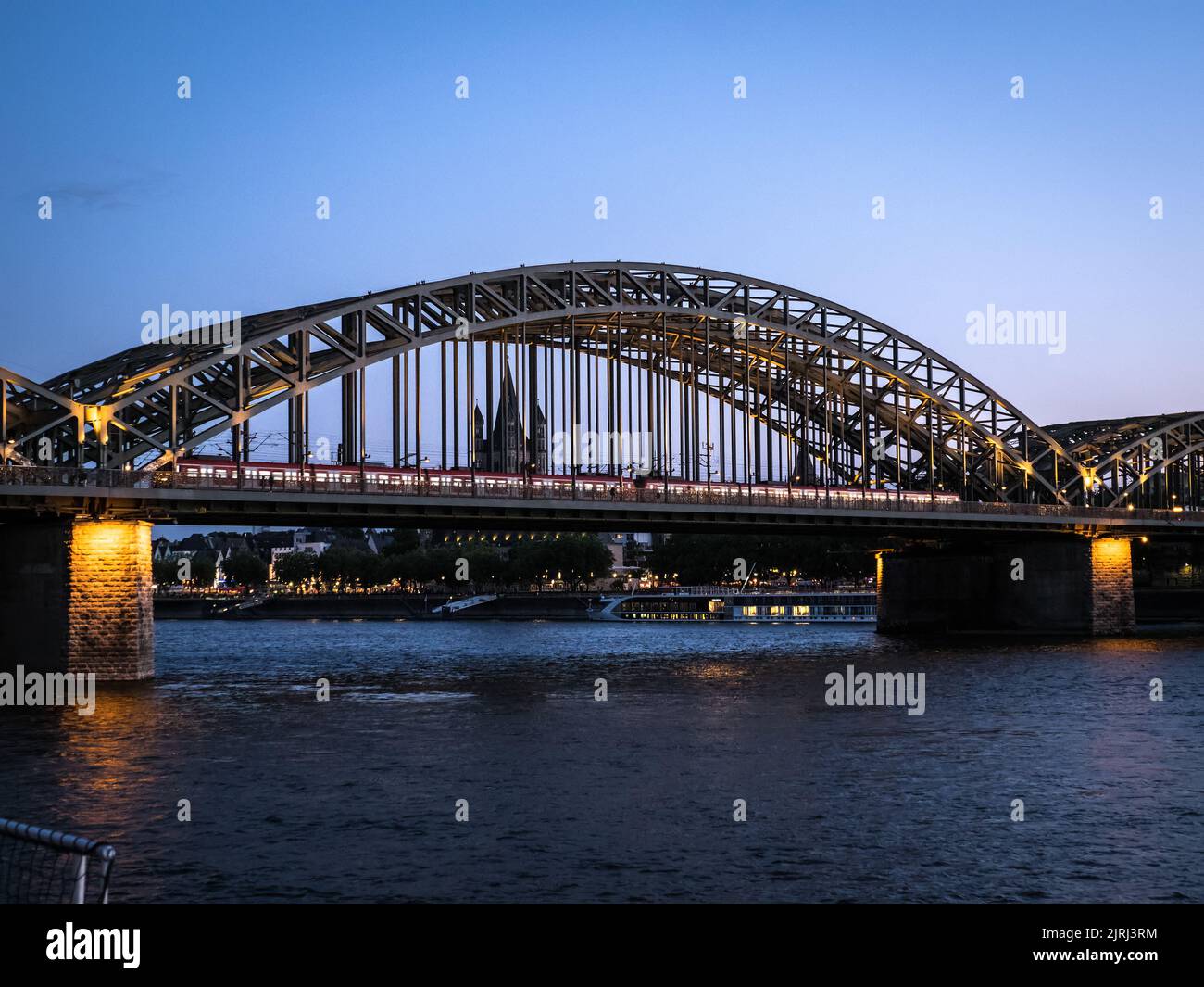 Evening view across the RHine of the Hohenzollern Bridge and Cathedral ...
