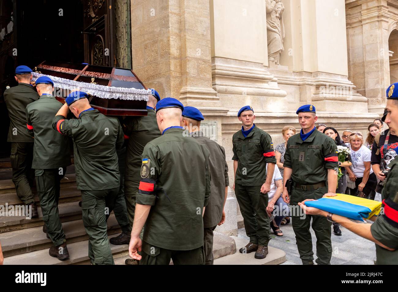 The coffin is assisted to the church as crowds attend a funeral of a ...