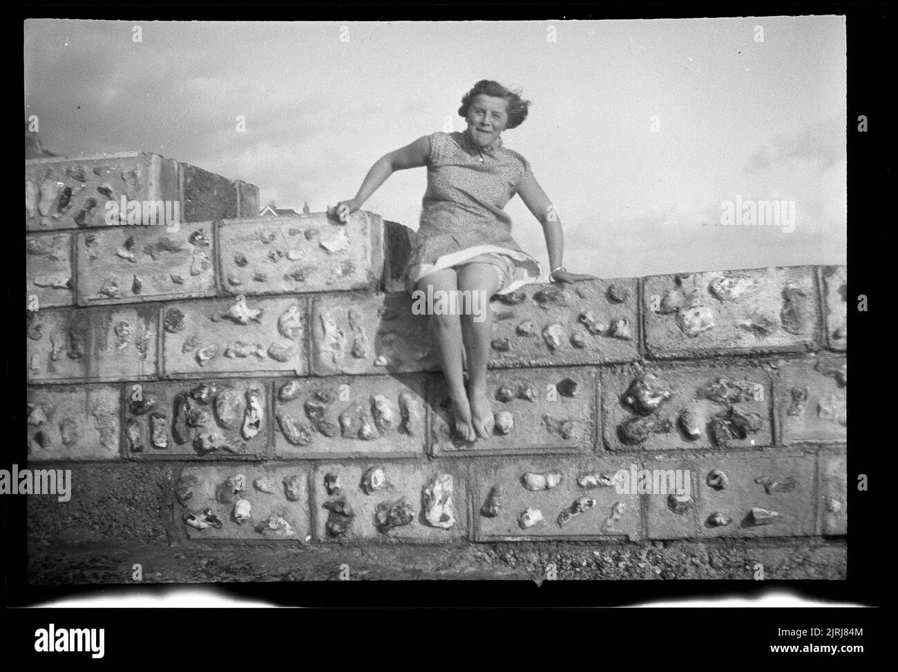 Paddy johnson sitting on stone wall at rottingdean hi-res stock ...