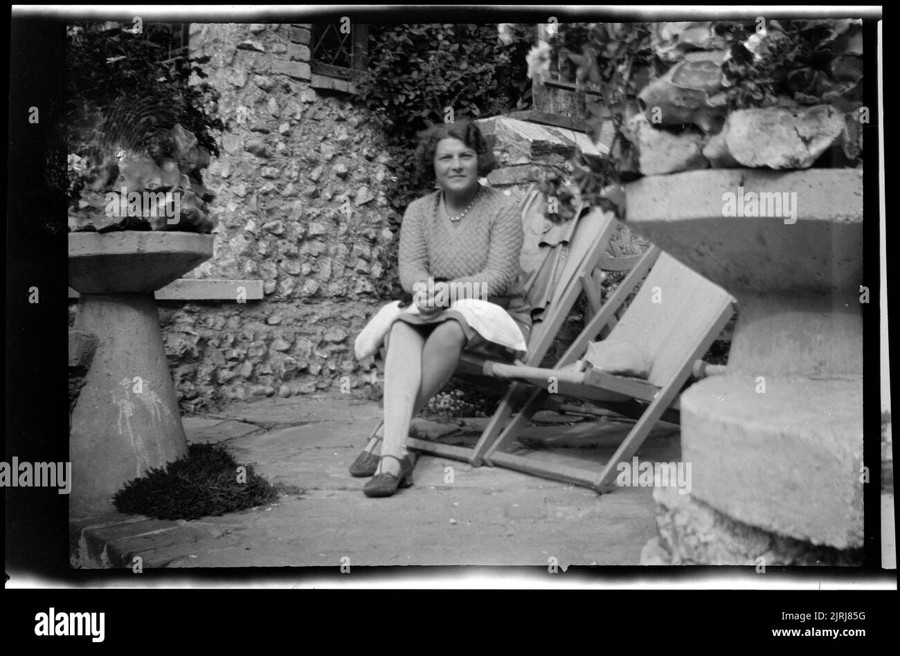 Paddy Johnson in garden surroundings at Rottingdean, Sussex, England ...