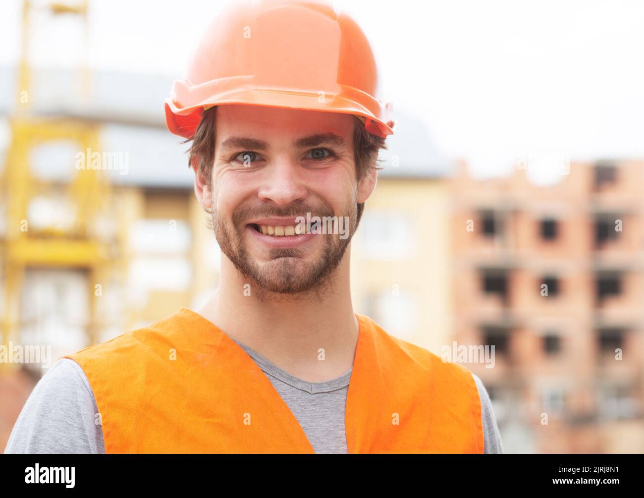 Construction worker man in work clothes and a construction helmet ...