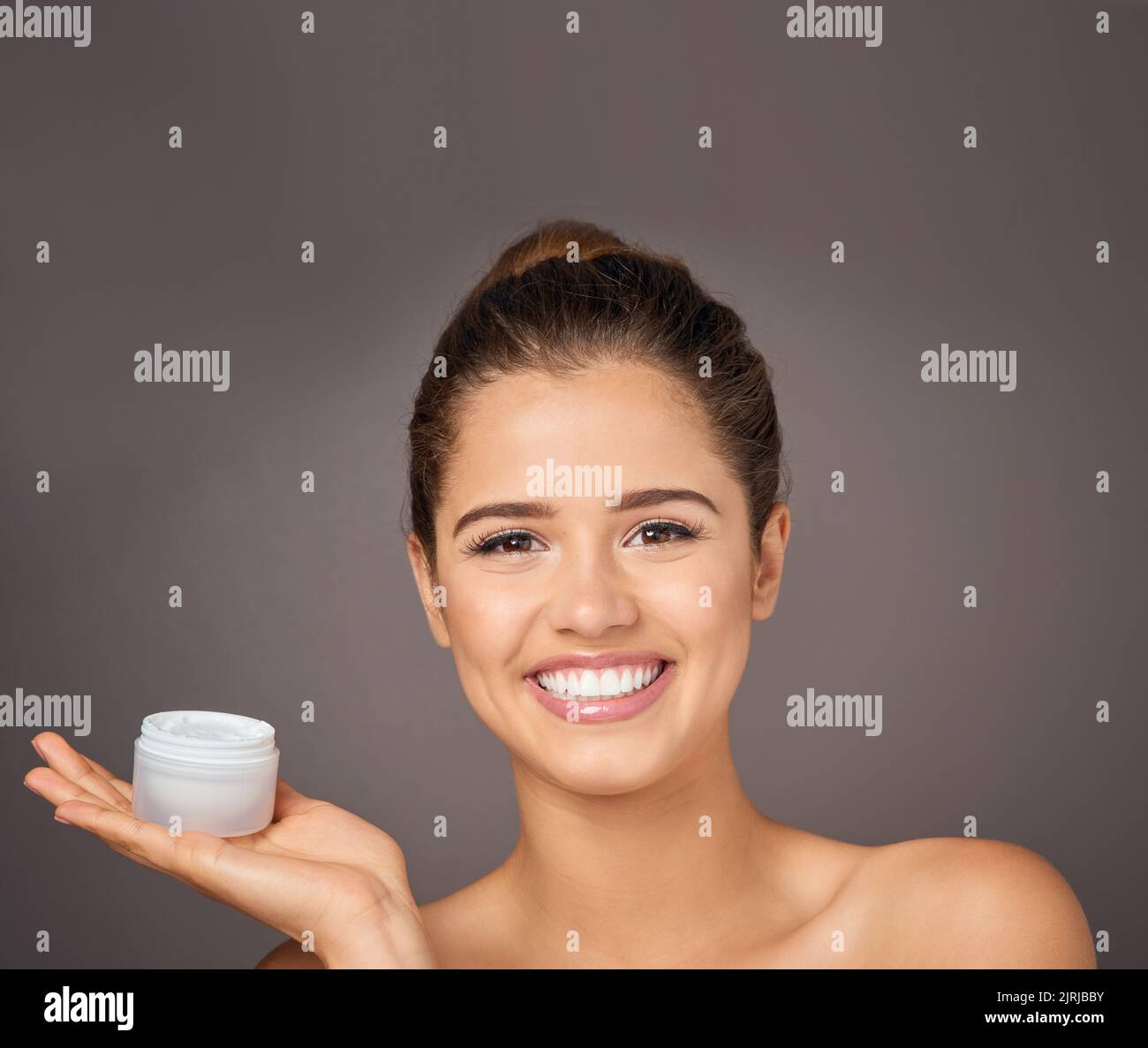 Only the best for my skin. Portrait of a beautiful young model holding ...