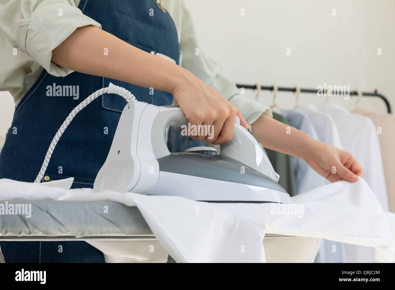 aesthetic laundry concept ironing shirt with clothes rack background Stock Photo - Alamy
