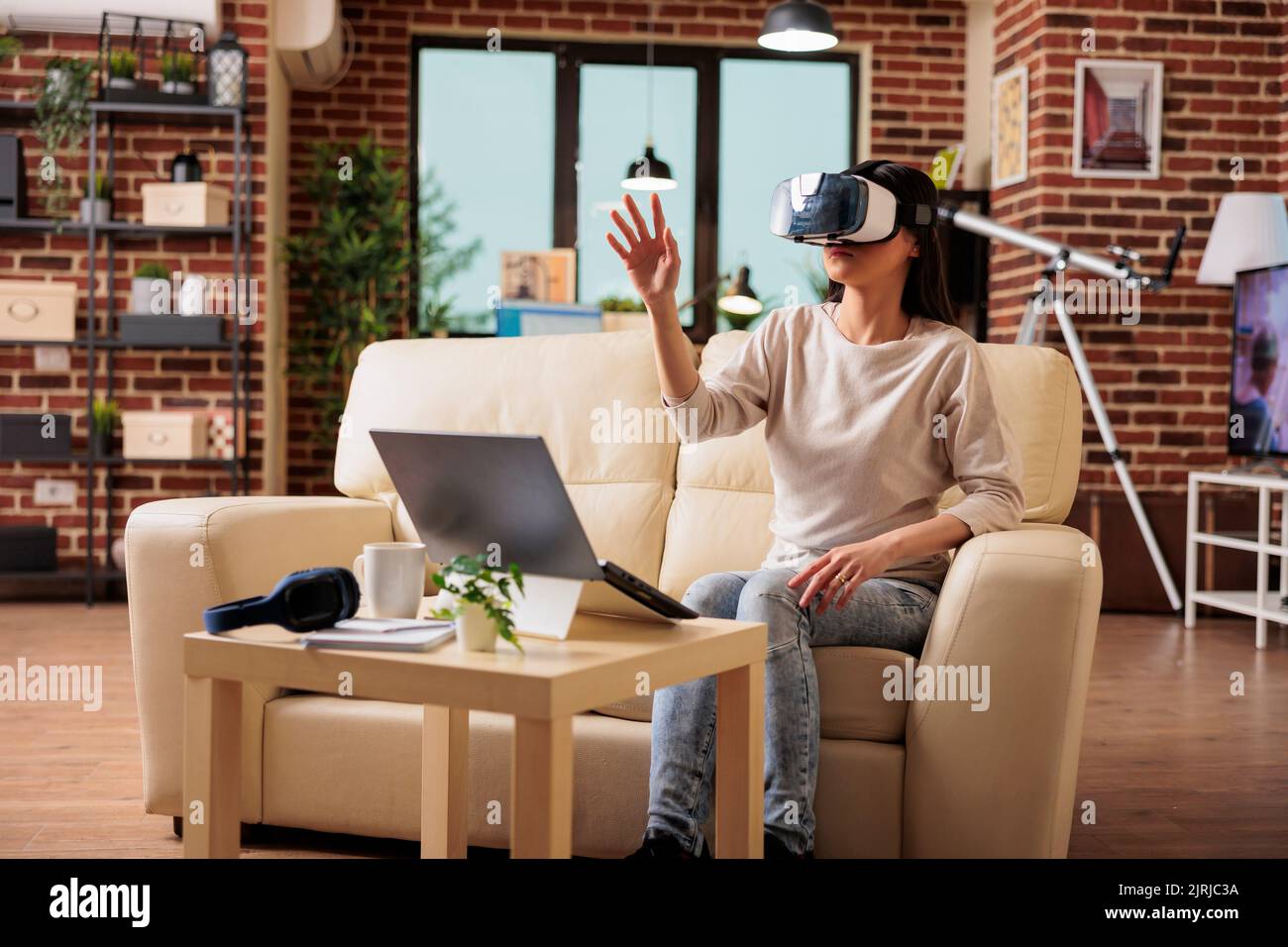 Happy asian woman enjoying wearing VR virtual reality headset, modern ...