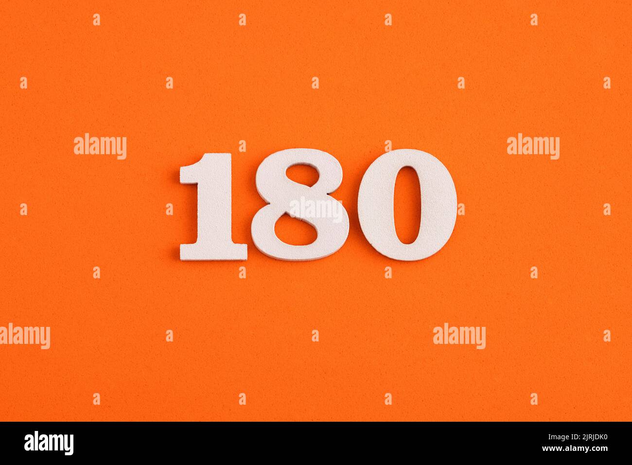 White wooden number 180 on eva rubber orange background Stock Photo - Alamy