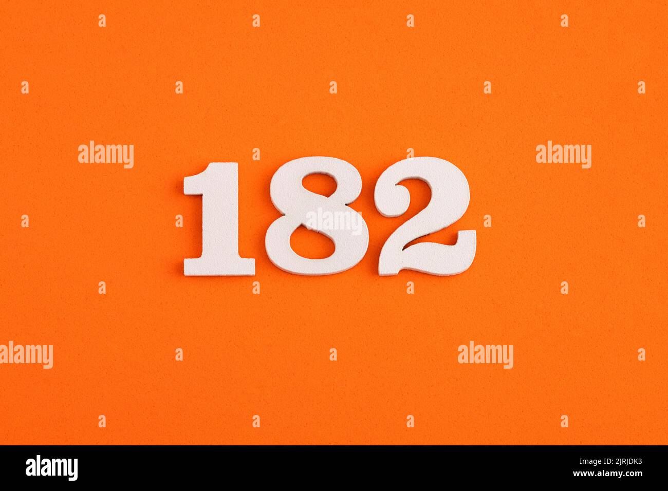 White wooden number 182 on eva rubber orange background Stock Photo - Alamy