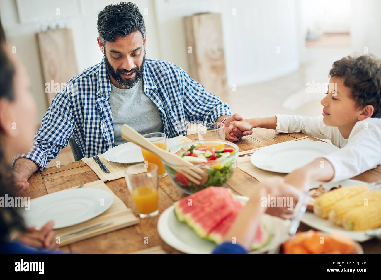 Always give thanks for your blessings. a family praying together before ...