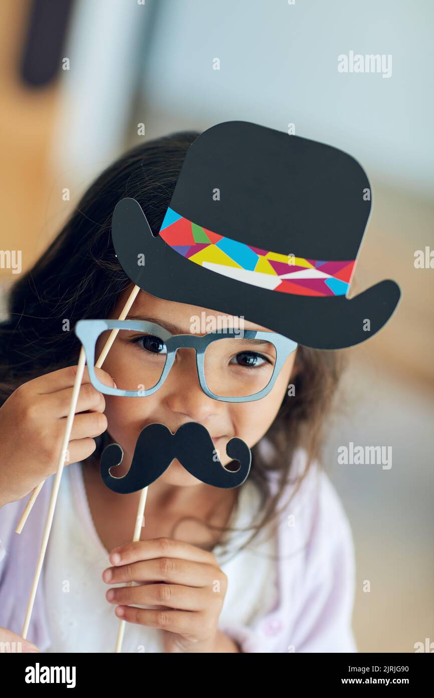 Shes a cutie in disguise. Portrait of a cute little girl posing with ...