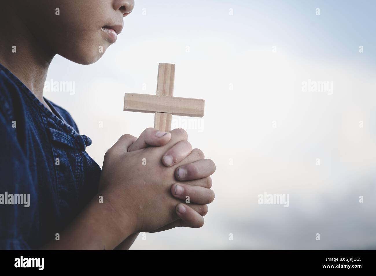 children worship God by holding christian Cross , christian concept ...