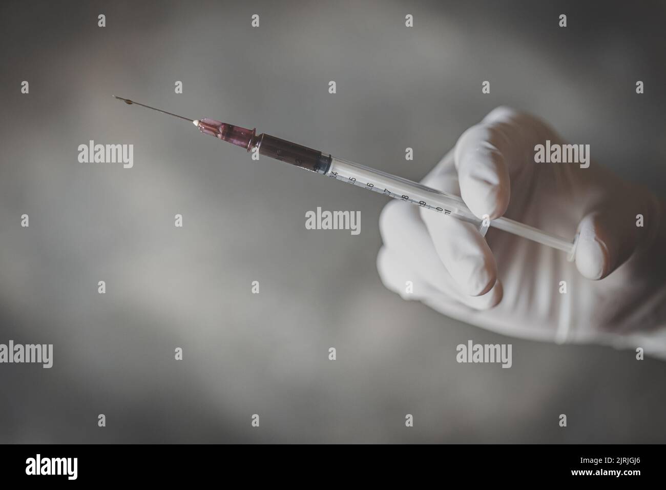 Man hand holds a syringe, drug abuse and danger addiction concept ...