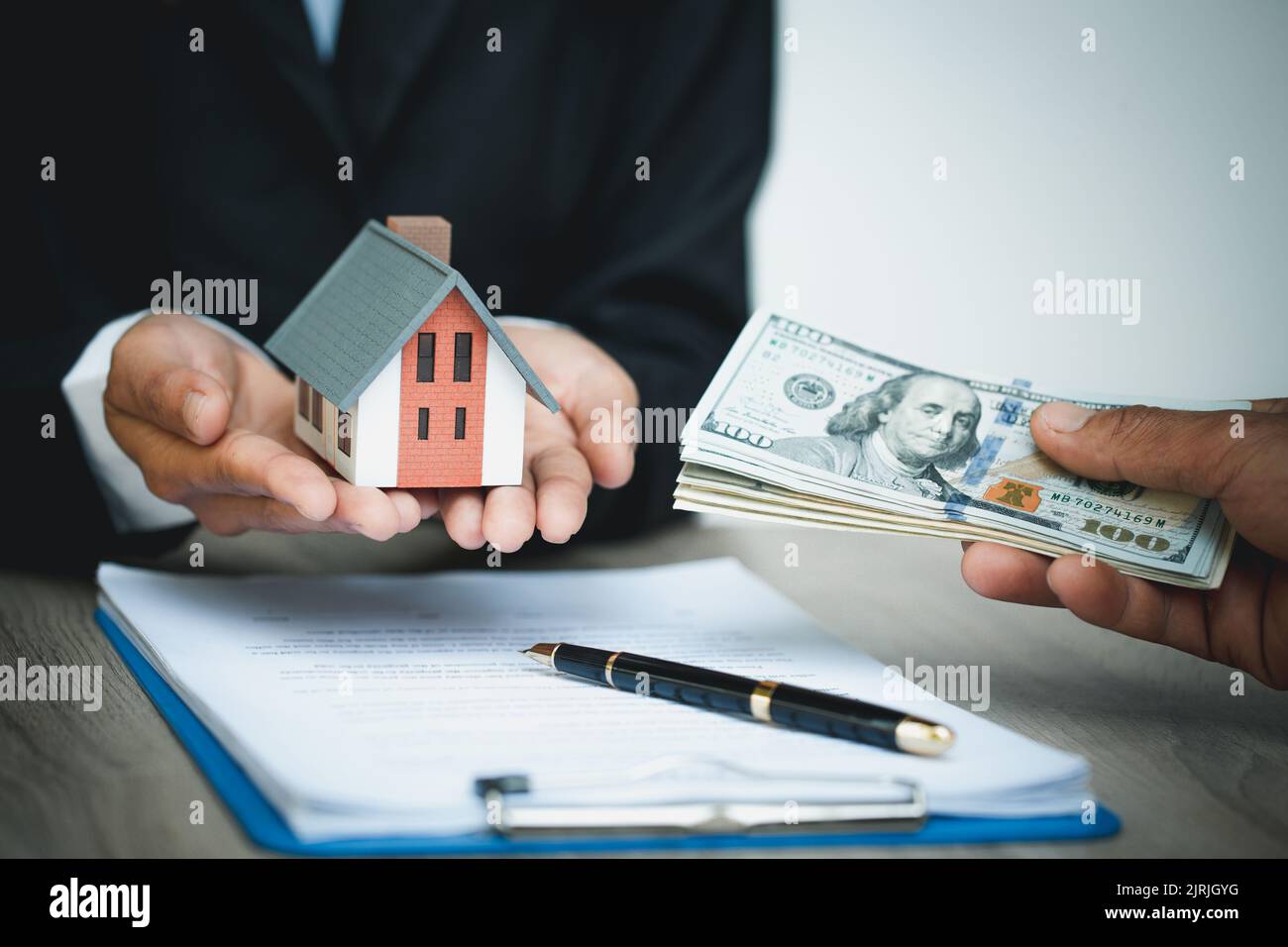 Hands giving house model to other hands with money. Concept of real ...