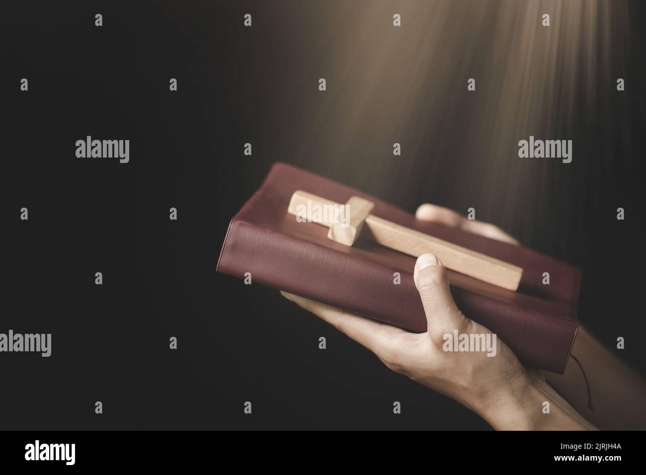 Human hand holds cross and bible, Worship, sins and prayer, Religious concept., Eucharist ...