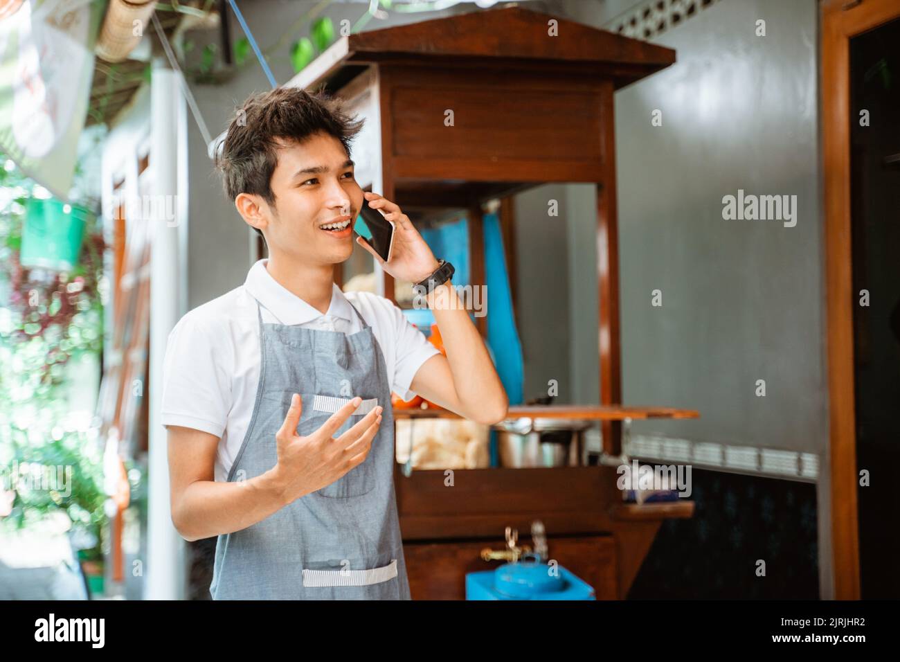 male merchant makes a call using a mobile phone Stock Photo - Alamy
