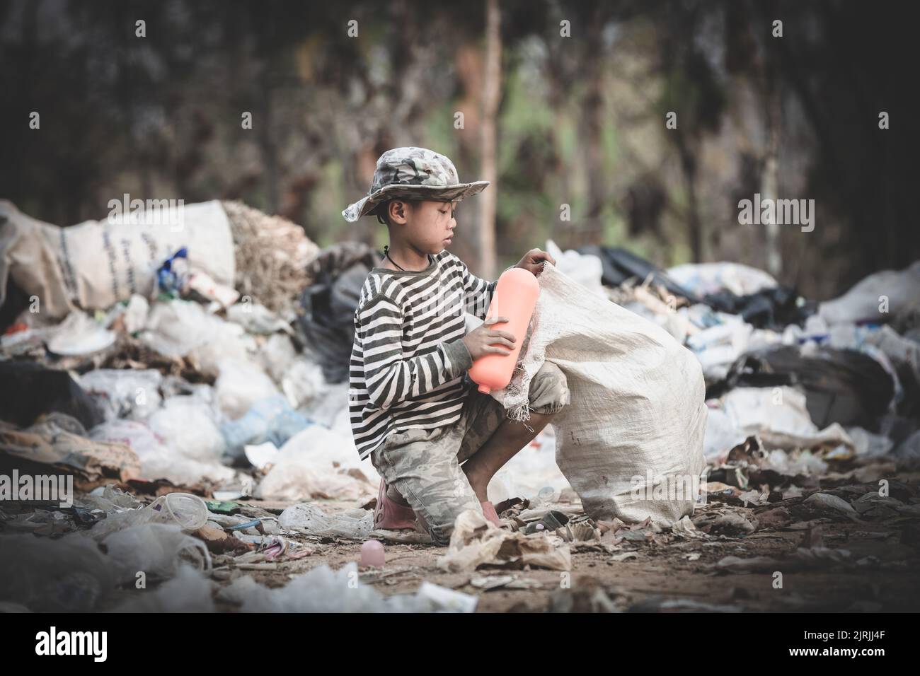 Poor boy collecting garbage in his sack to earn his livelihood, The ...