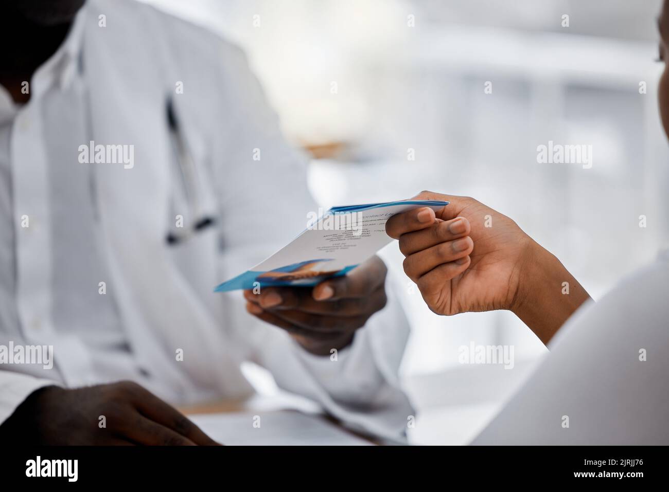 Hands of doctor giving flyer to patient about hospital help, medical ...