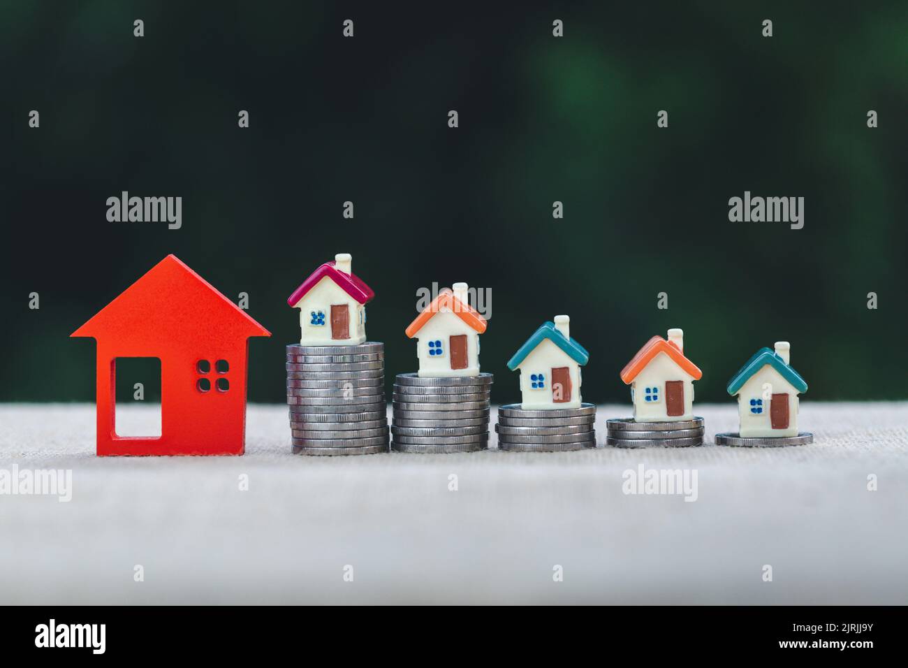 coin stack with house model, savings plans for housing ,financial ...