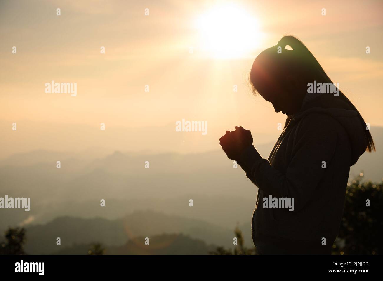 woman praying in the morning concept of christianity rising sun ...