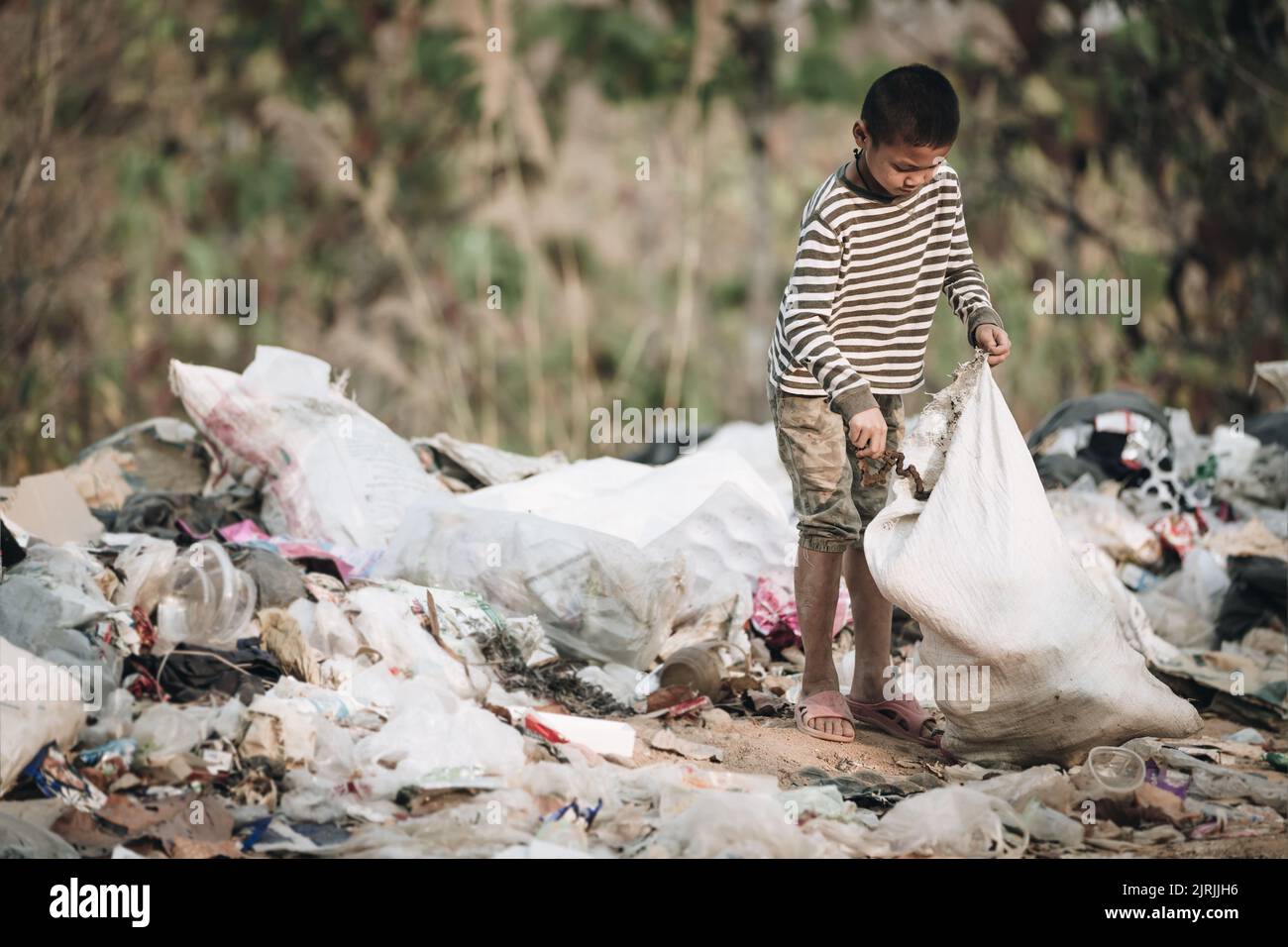 Poor children. Collecting recyclable waste to sell. Pollution and ...