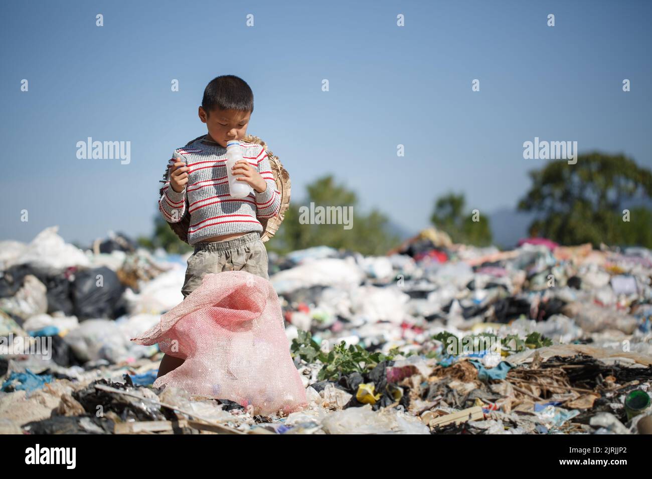Poor children. Collecting recyclable waste to sell. Pollution and ...