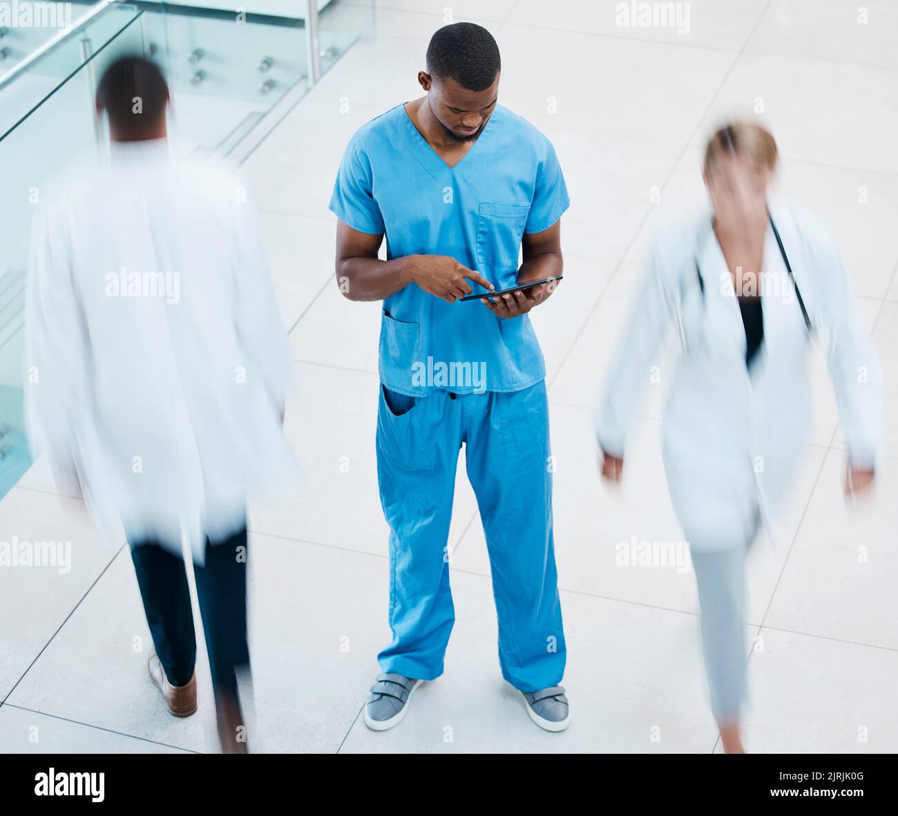 Doctor walking with patient in hospital corridor hi-res stock ...