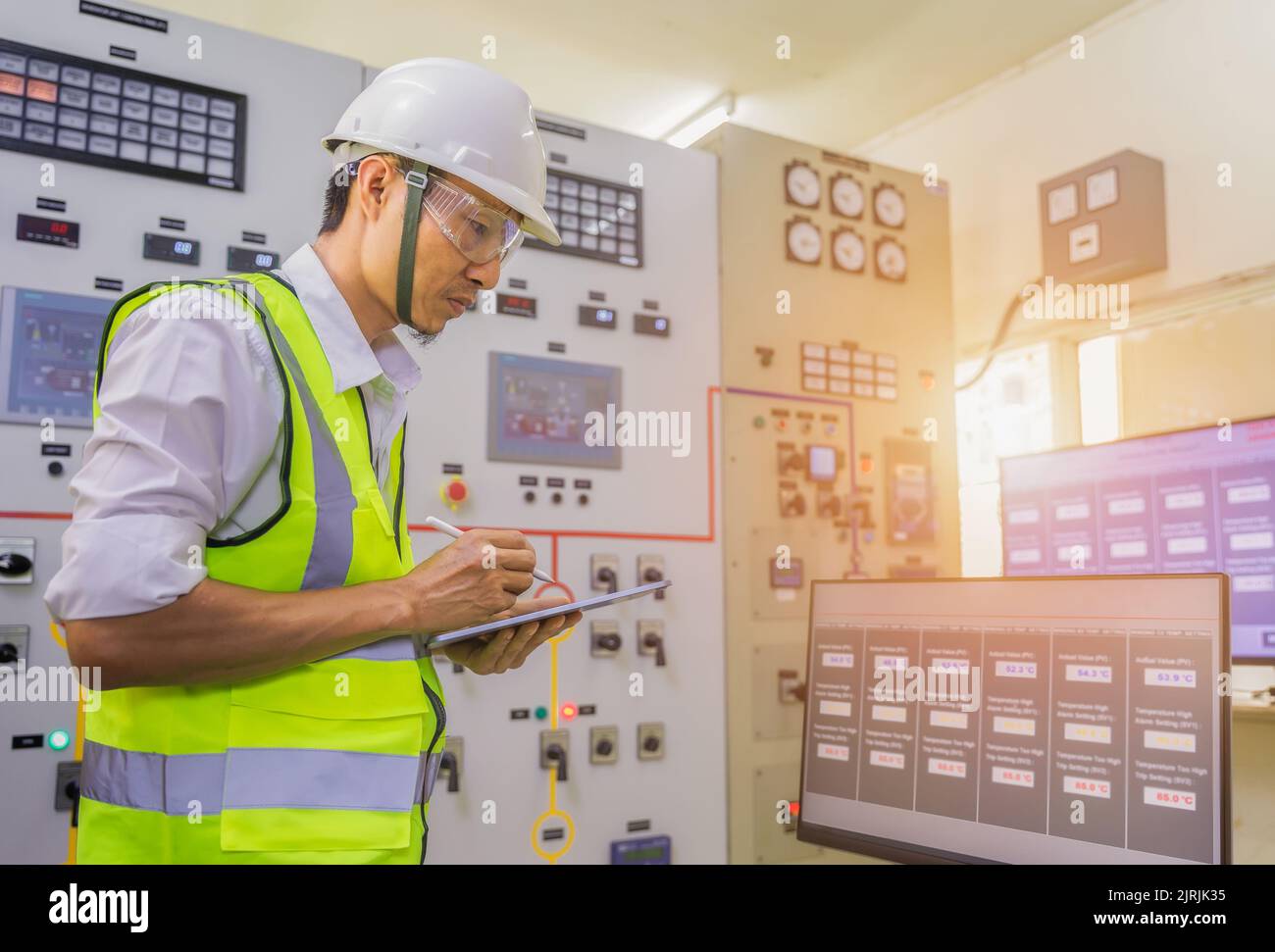 Engineer working on the checking status switchgear electrical energy ...