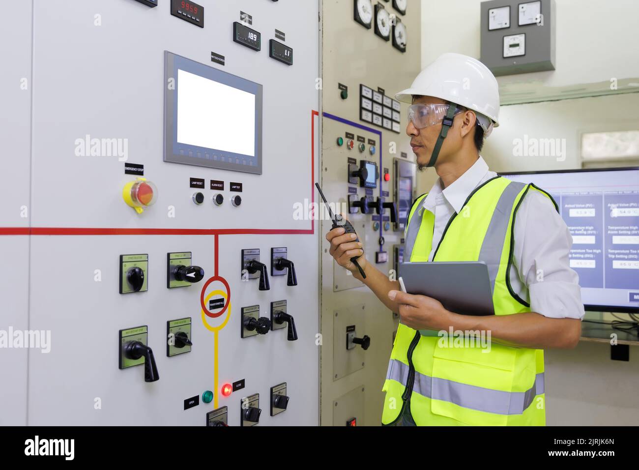 Experienced electrician working in power plant control room. Engineer ... Experienced electrician working in power plant control room. Engineer ...