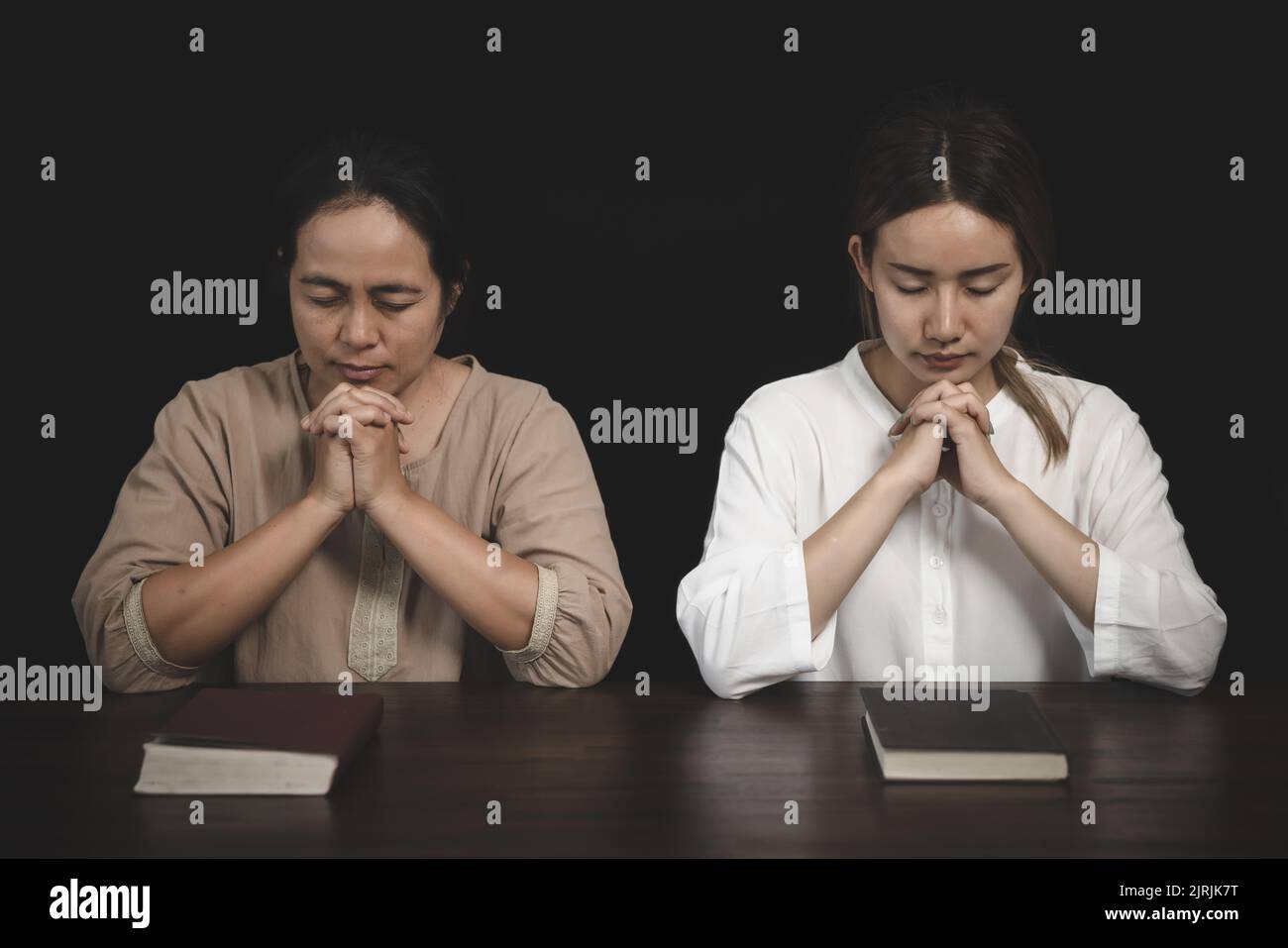 Two women are praying for God's blessing. The idea of praying to the ...