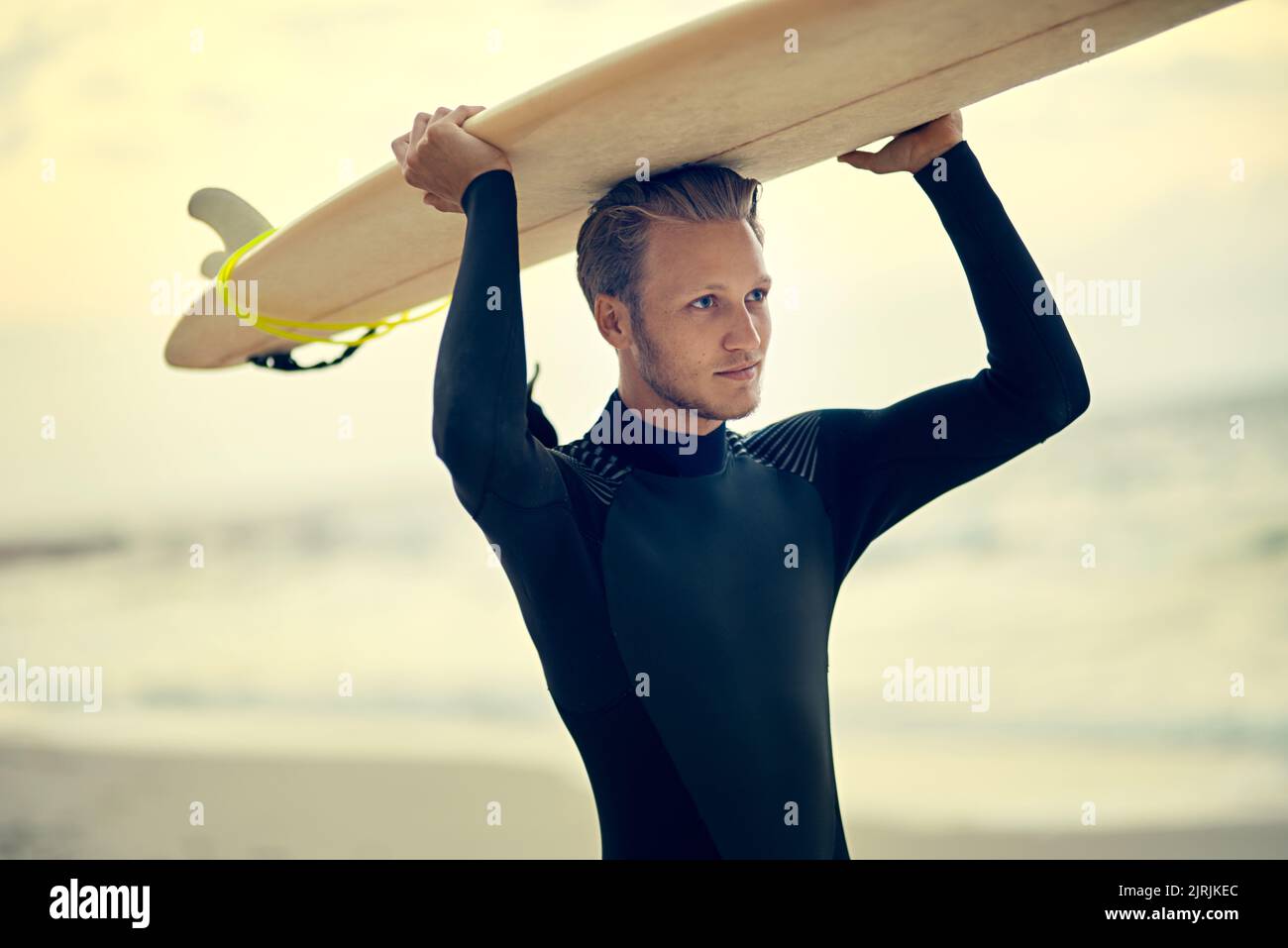 Surfers have saltwater in their veins. a laid-back young surfer ...