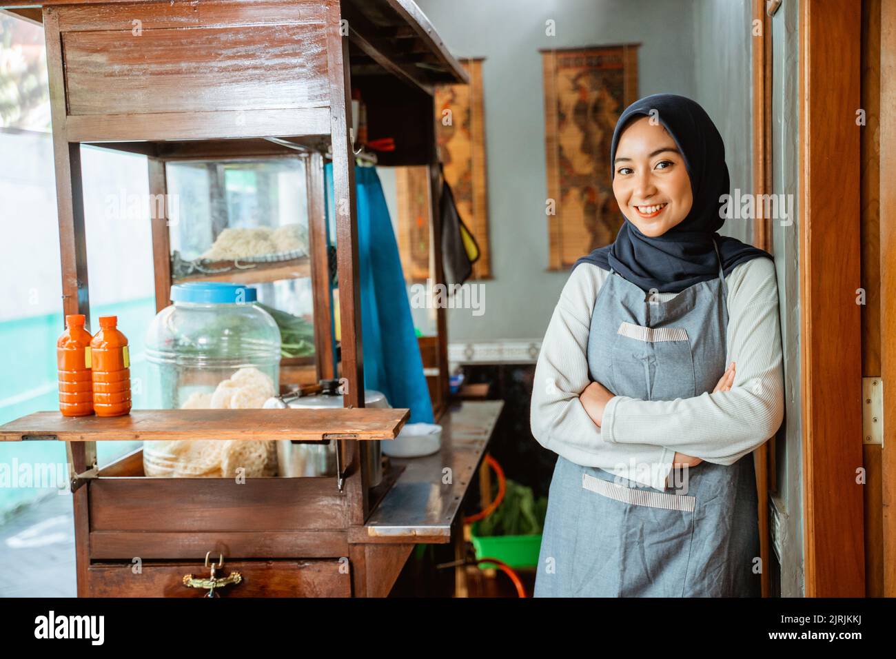 asian hijab woman wearing apron smiling with hands crossed Stock Photo ...