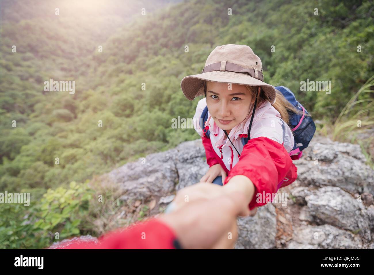 Helping hand couple hiker hi-res stock photography and images - Alamy
