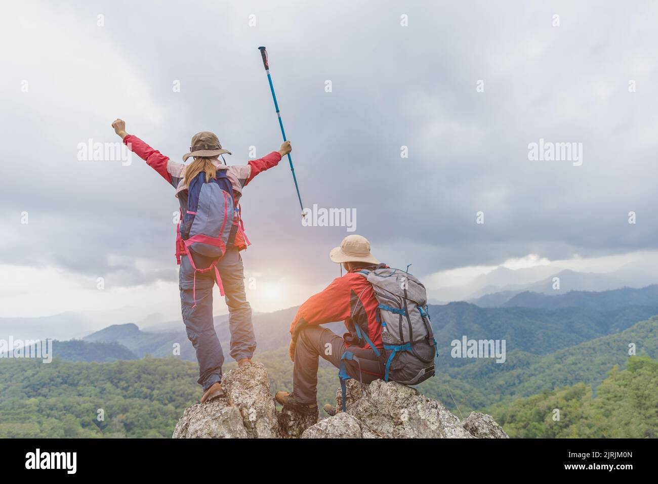 Active climbers enjoy the scenery. Male and female backpackers with ...