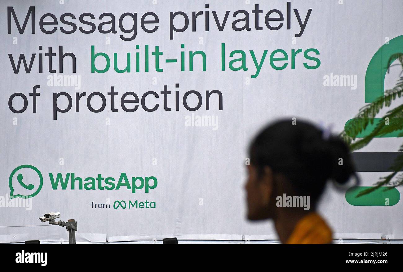 Mumbai, India. 24th Aug, 2022. A woman looks at WhatsApp logo displayed ...