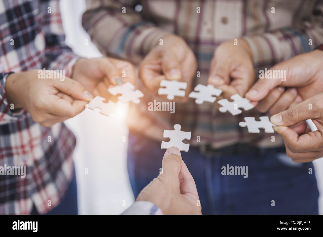 Group of business people assemble jigsaw puzzles, concepts of ...