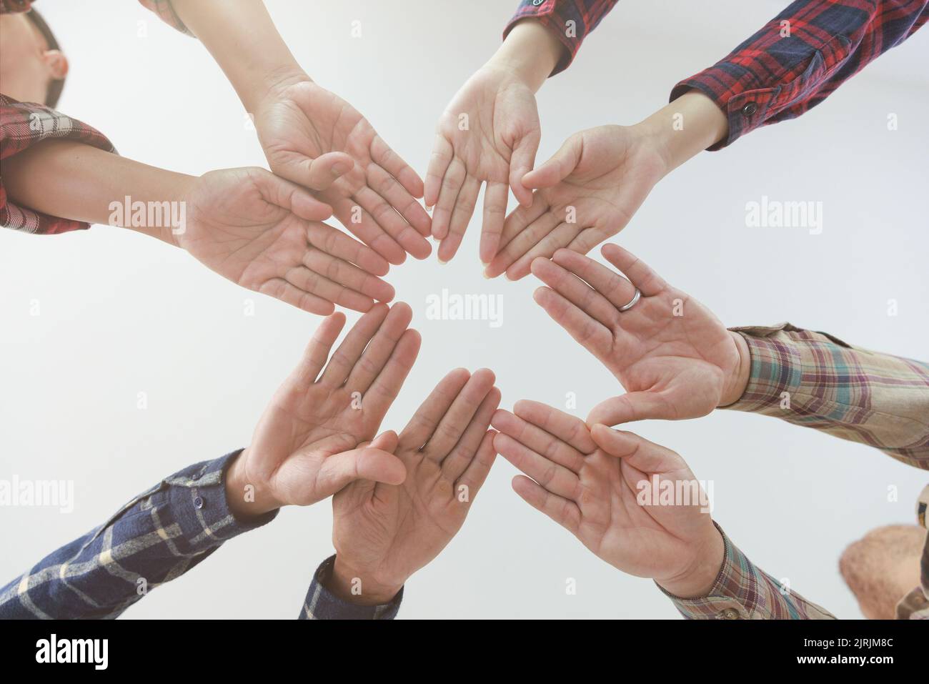 Young businessmen put their hands together, piles of hands, unity and ...