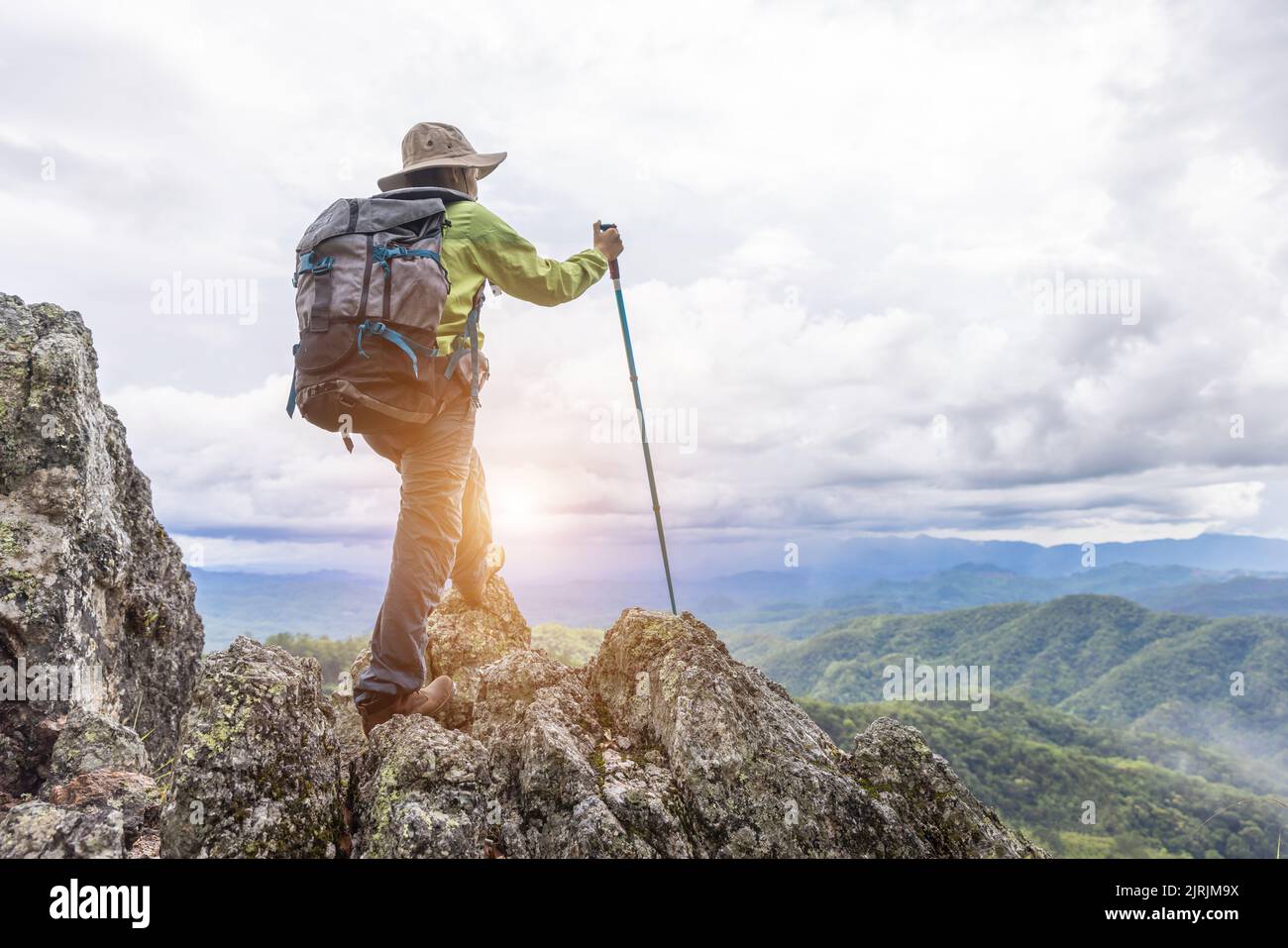 climber standing on a rock on the mountain Stock Photo - Alamy