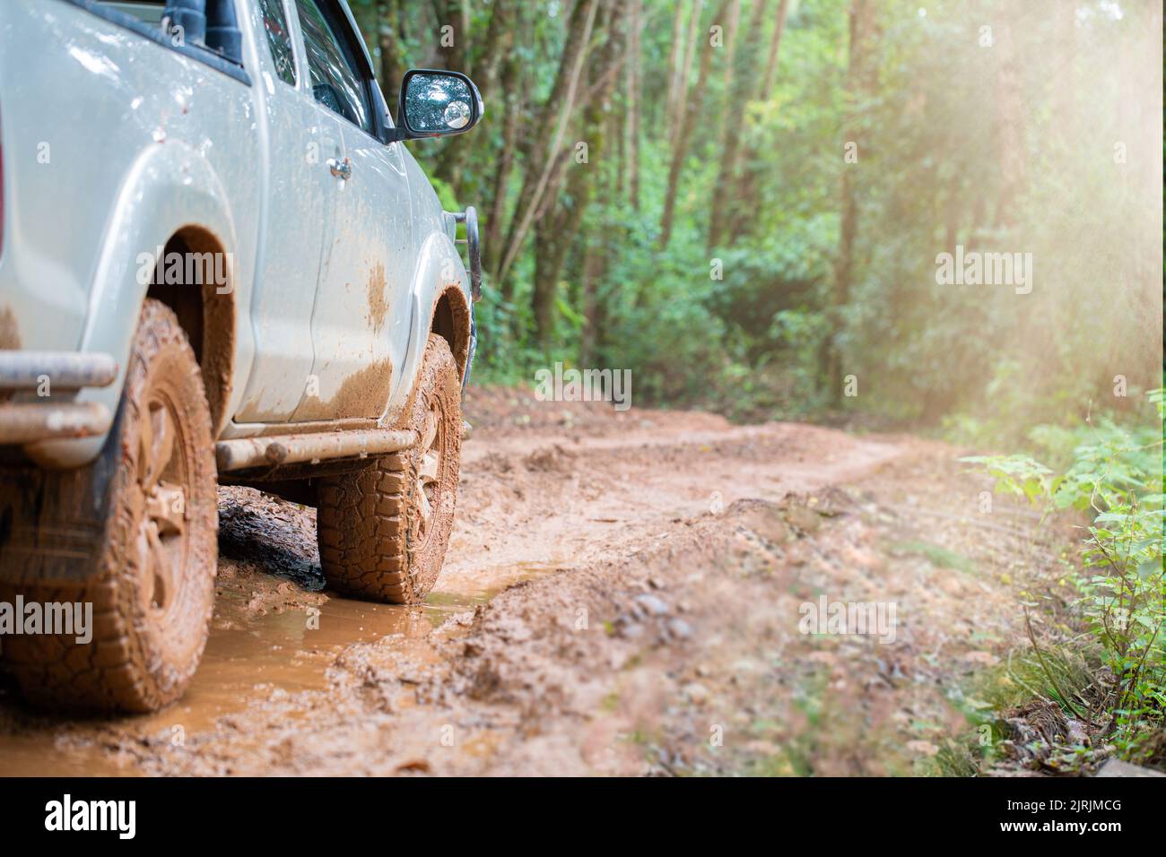 Muddy off-road vehicles, off road trip on mountain road sunset ...