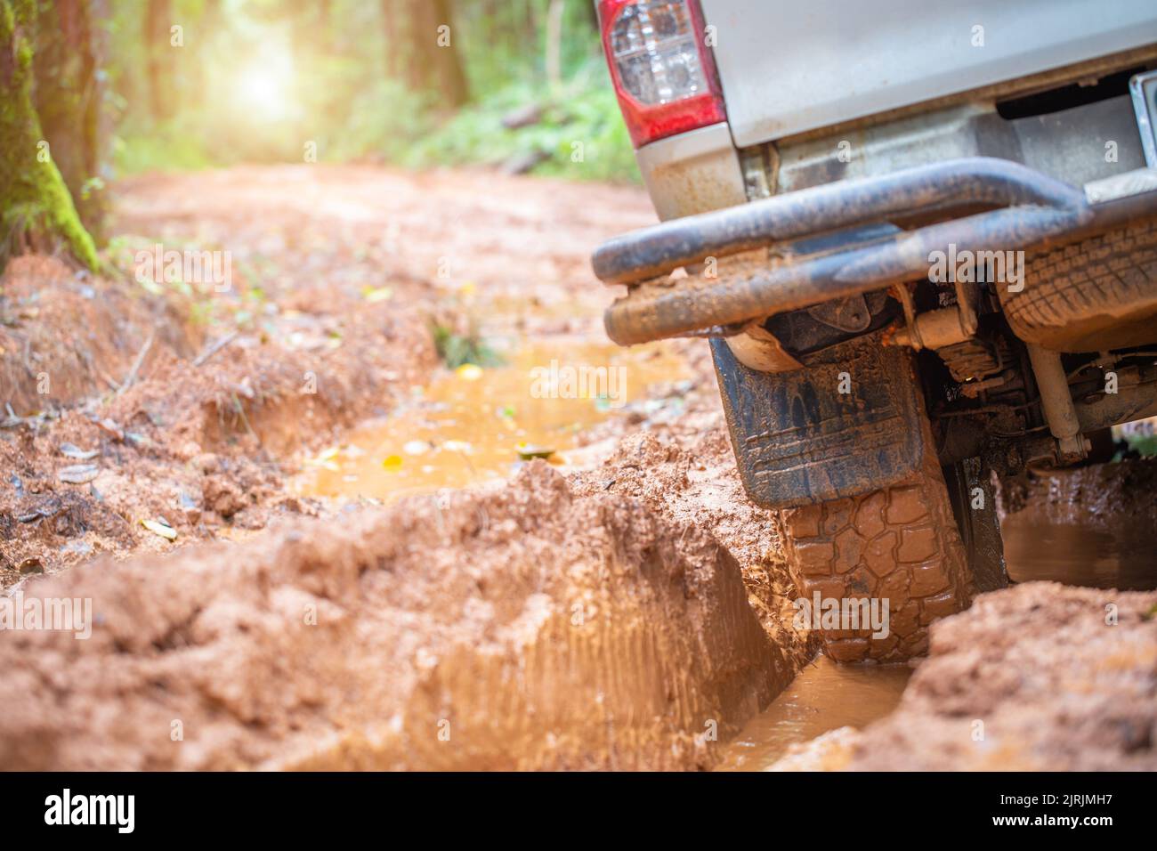 Muddy off-road vehicles, off road trip on mountain road sunset ...